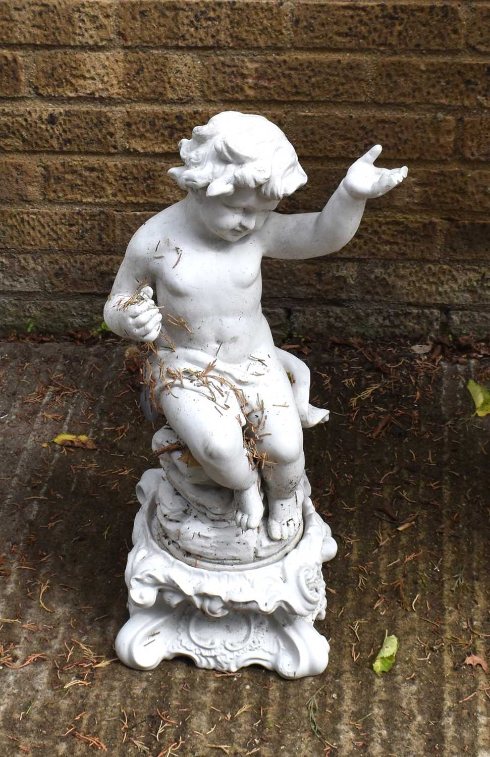 Lot 498 - A 20th century garden cherub figure on