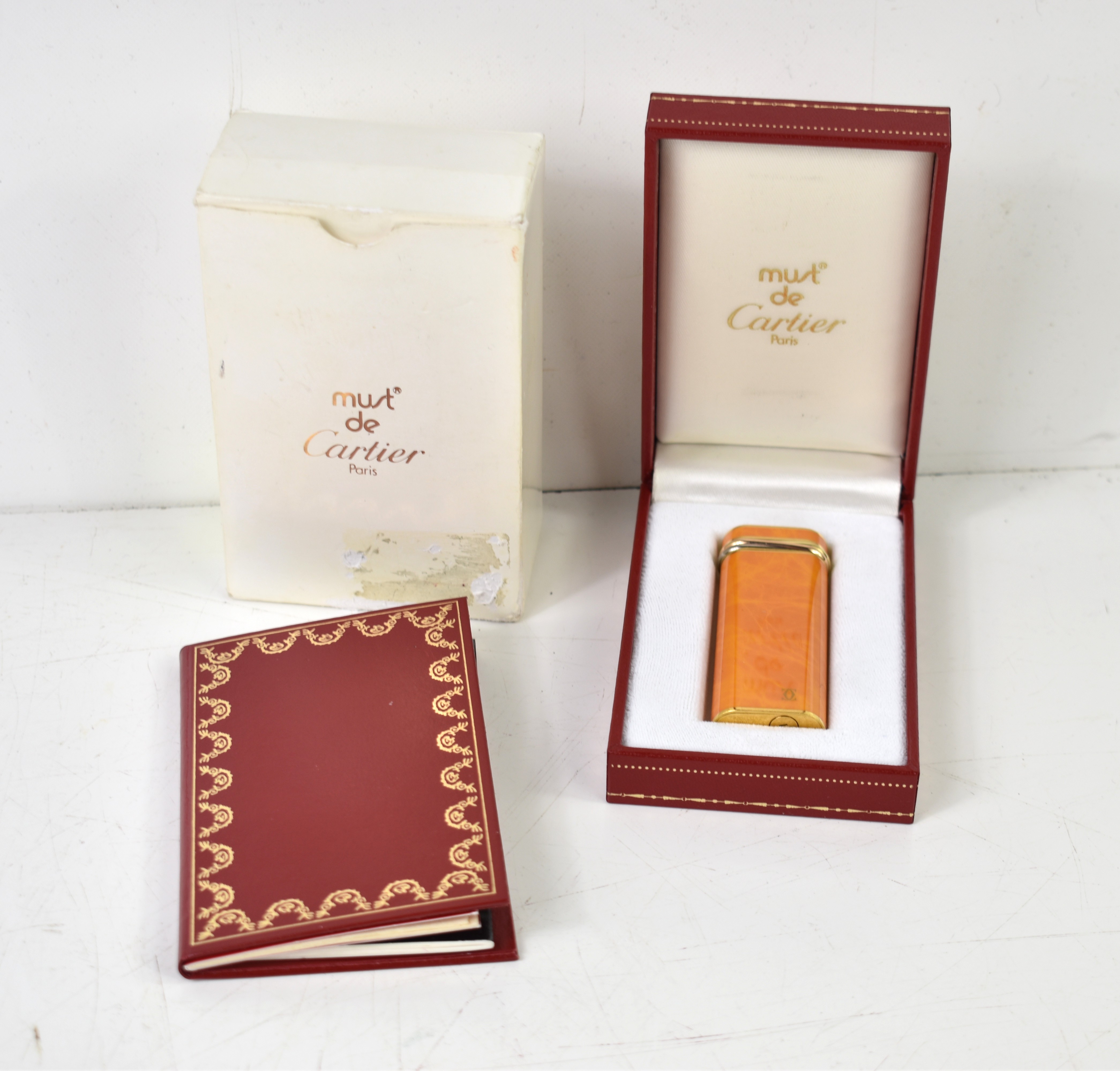 Lot 180 - A Cartier orange lacquer and gold plated